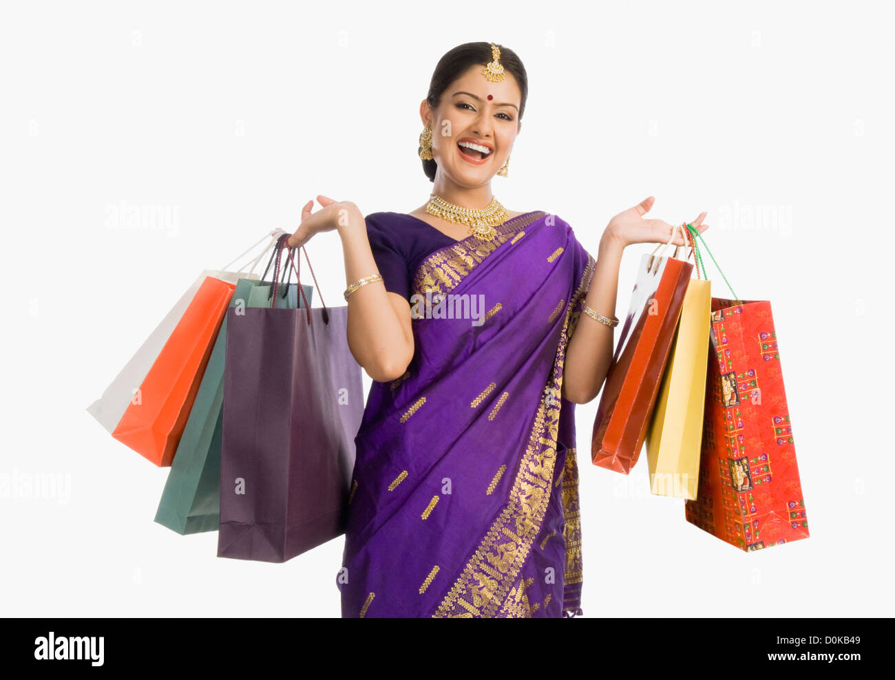 Beautiful Assamese woman holding shopping bags and smiling Stock Photo ...