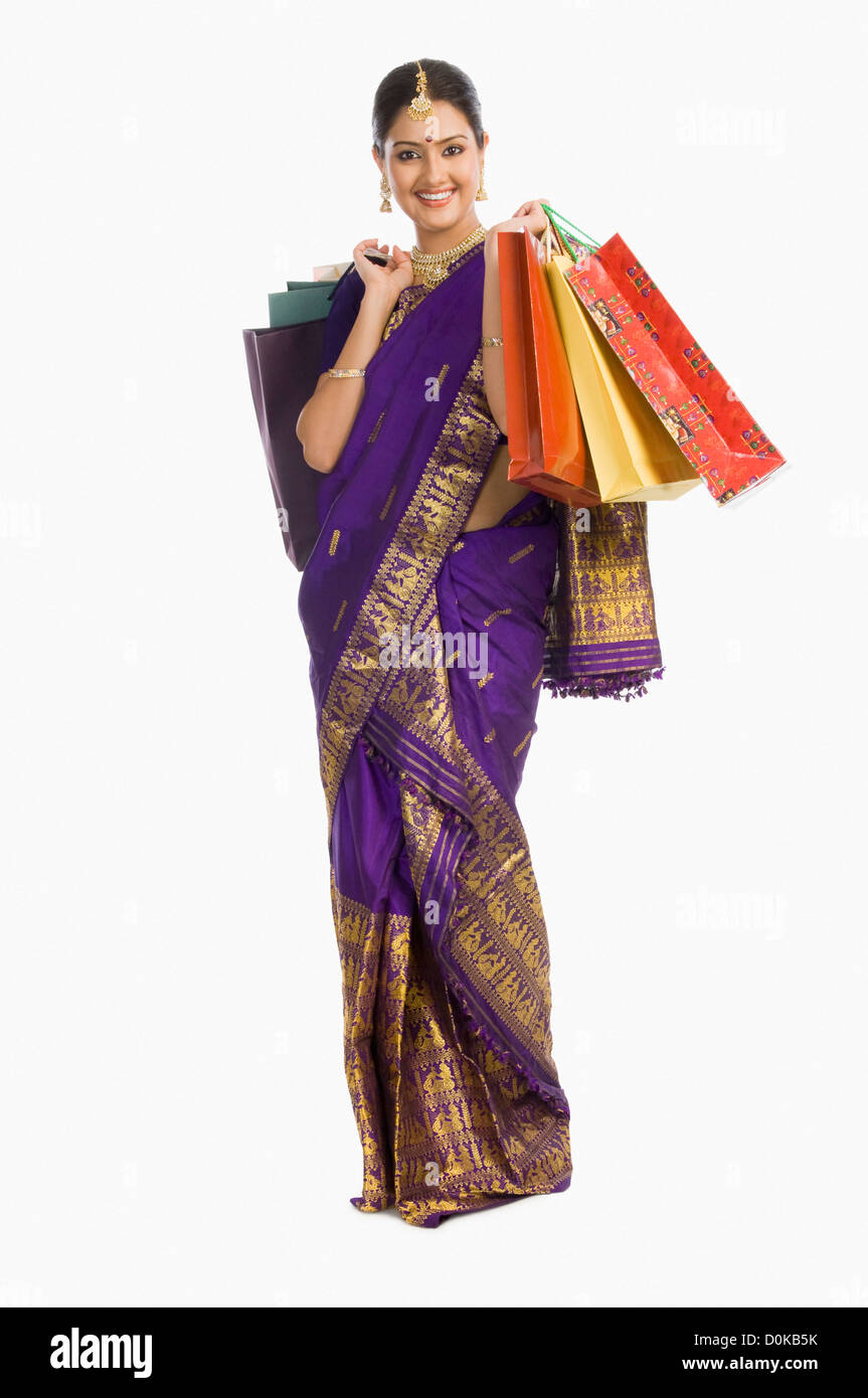 Beautiful Assamese woman holding shopping bags and smiling Stock Photo ...