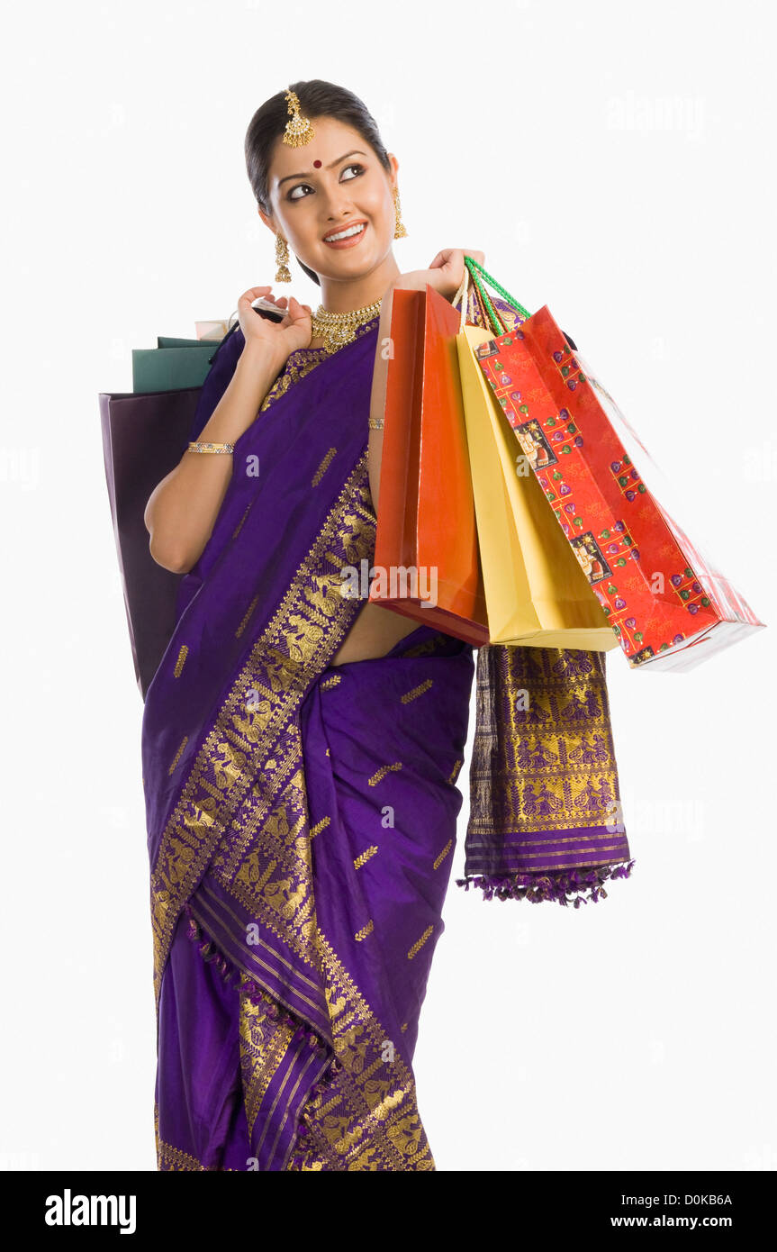 Beautiful Assamese woman holding shopping bags and smiling Stock Photo ...