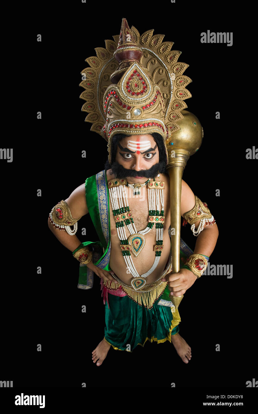 Portrait of a stage artist dressed-up as Ravana and holding a mace ...