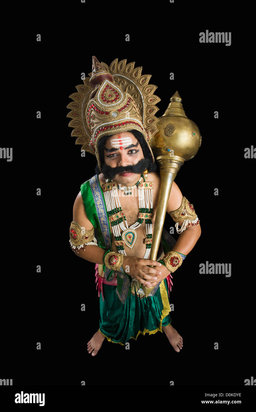 Portrait of a stage artist dressed-up as Ravana and holding a mace ...