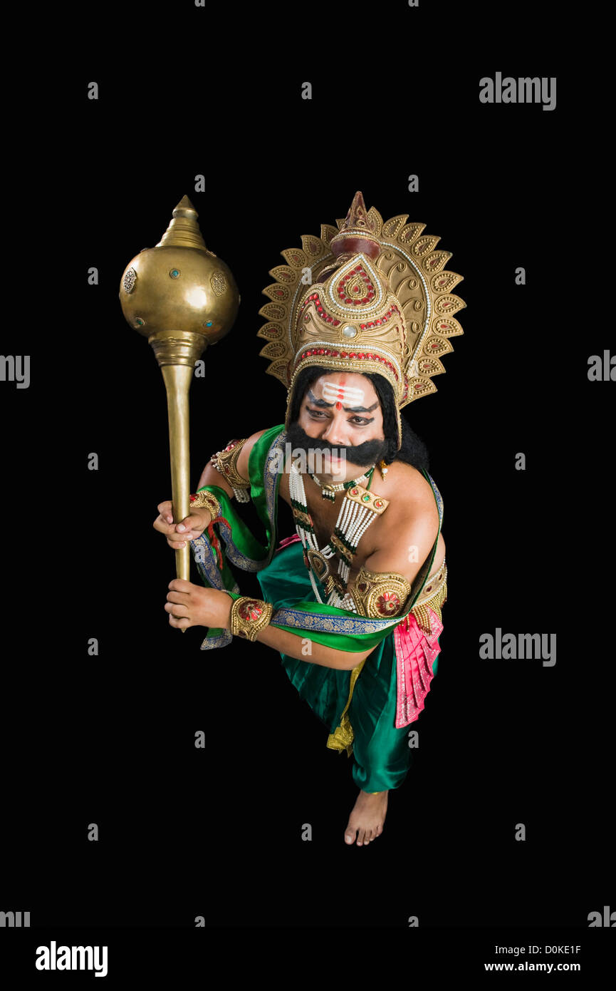 Portrait of a stage artist dressed-up as Ravana and holding a mace ...