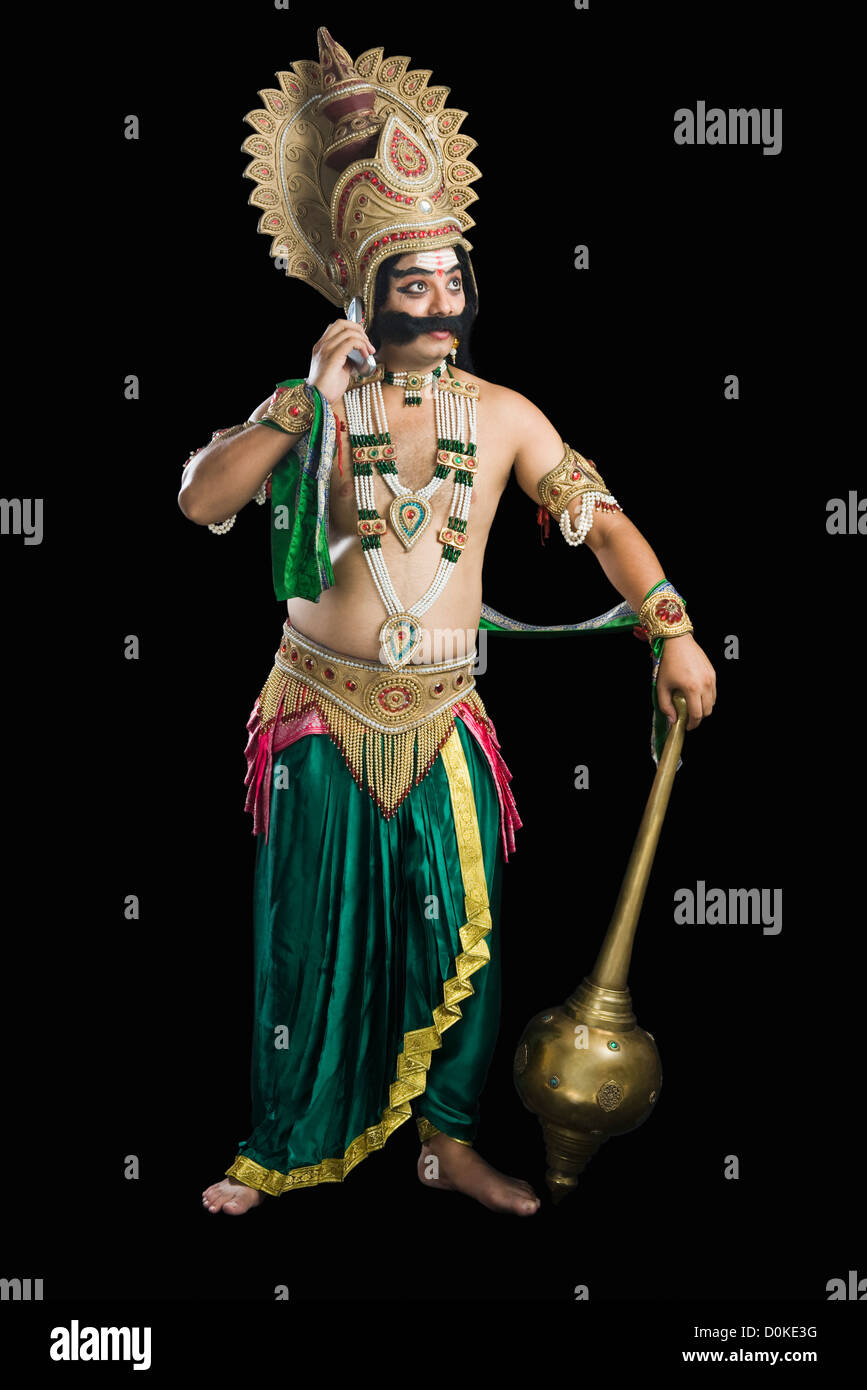 Man dressed-up as Ravana talking on a mobile phone Stock Photo - Alamy