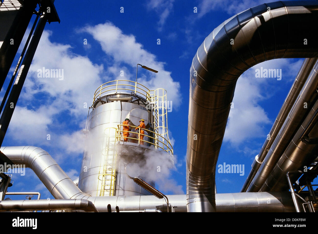 Workers measure emissions at a chemical factory Stock Photo - Alamy