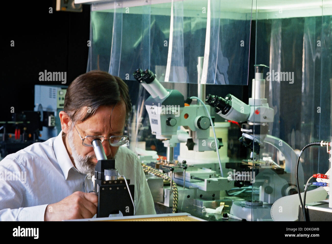 A scientist at a microscope Stock Photo - Alamy