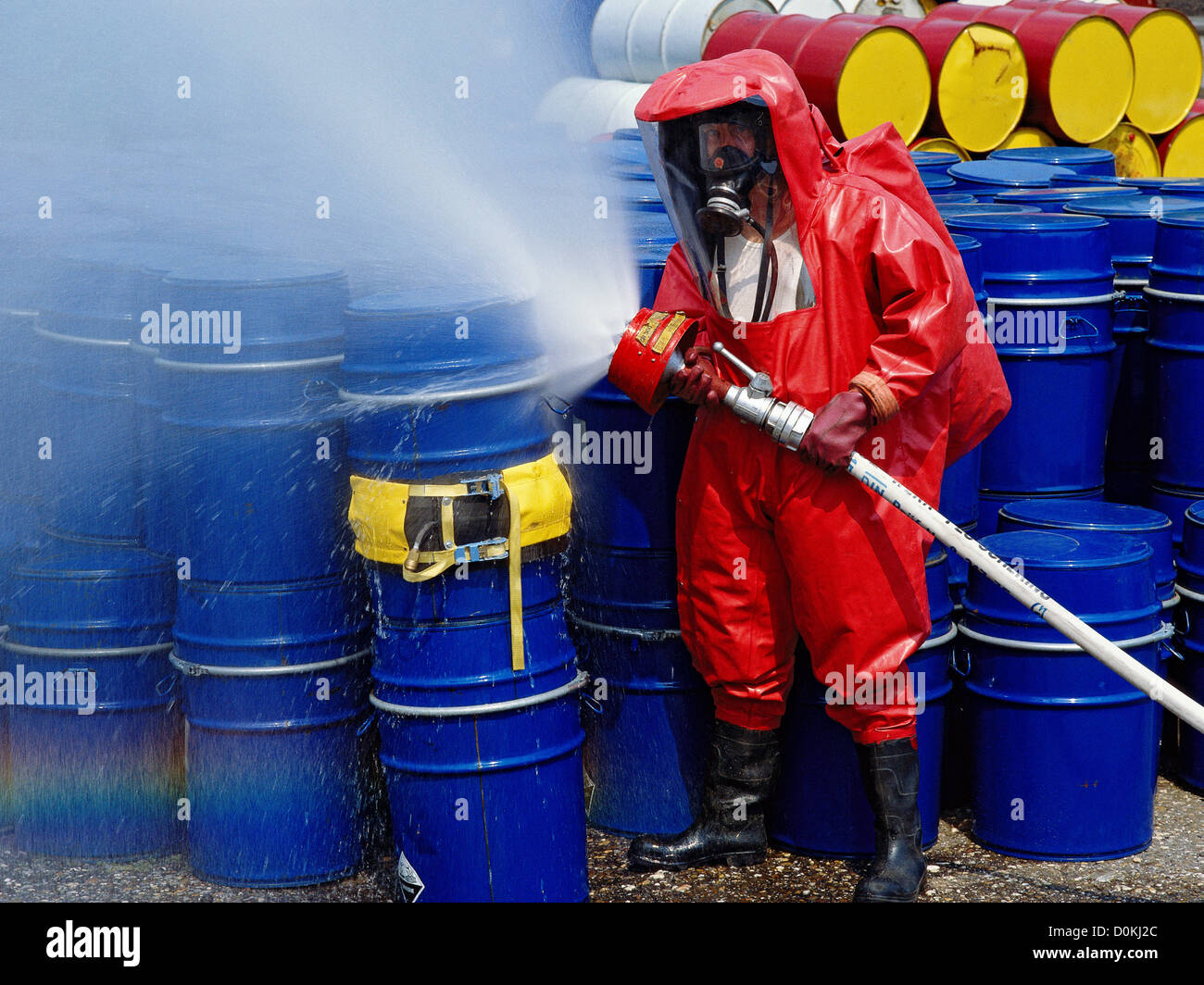 A fireman in a protective suit fighting fire at a chemical accident ...