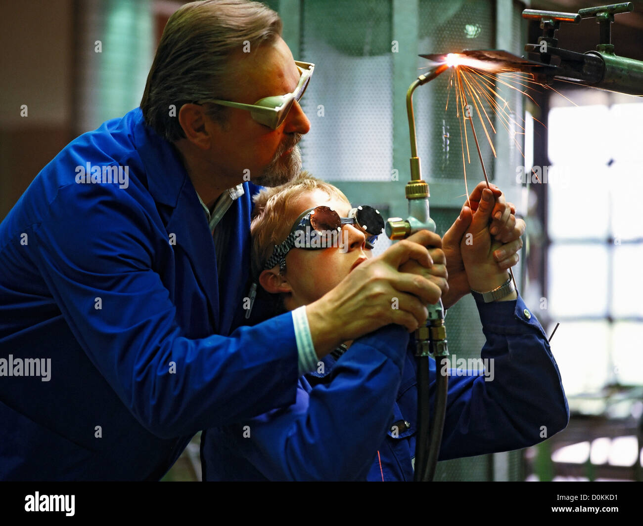 Vocational training for metal working. A trainer and apprentice at a ...