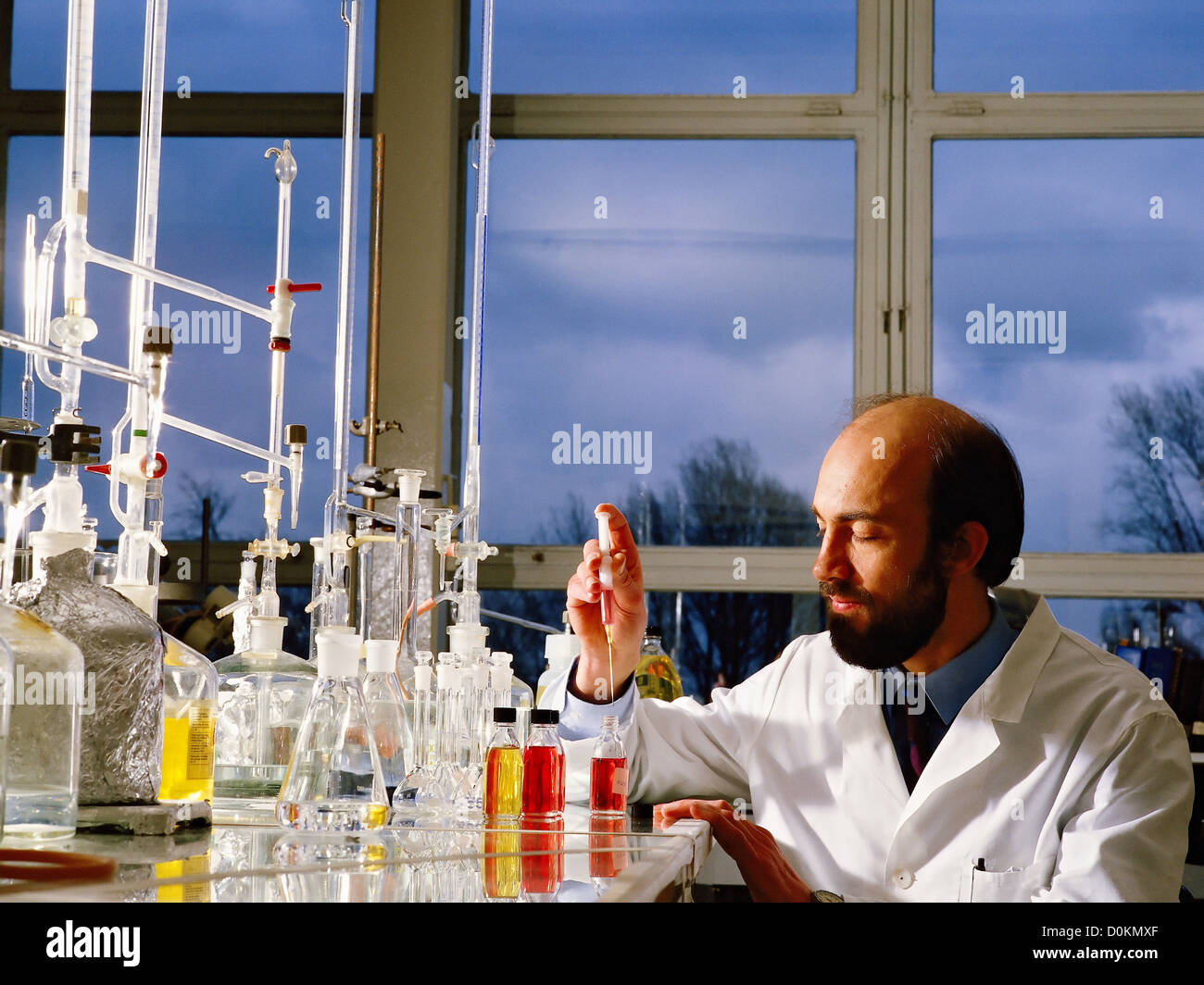 A chemist in a research and development laboratory prepares samples ...