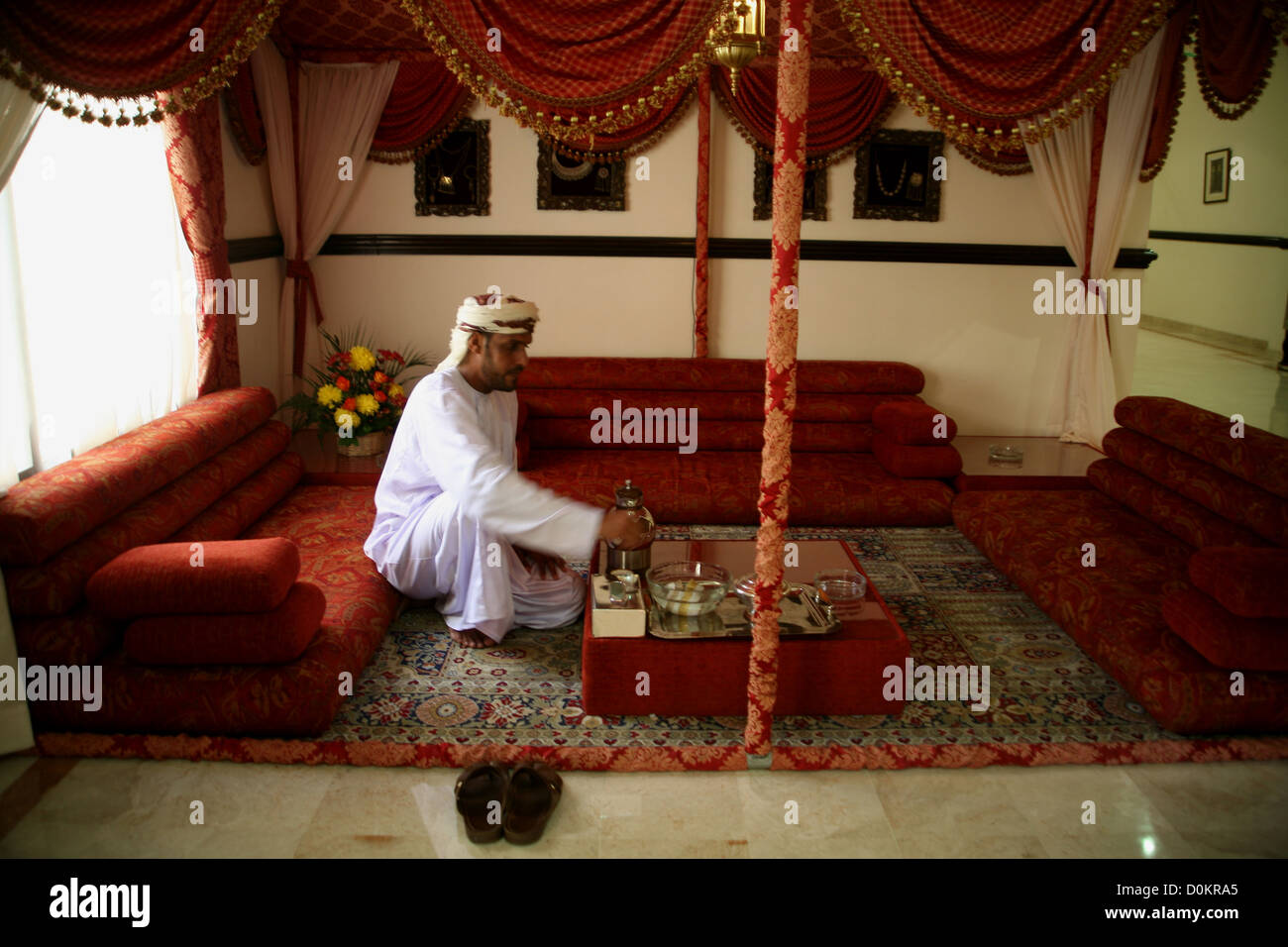An Omani man ready to pour coffee in a traditional cafe in Muscat ...