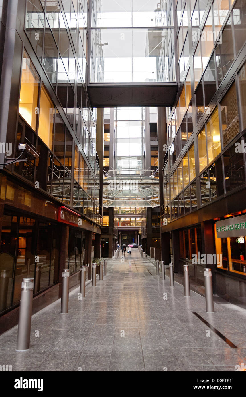 Looking down a pedestrian lane between modern office buildings in ...