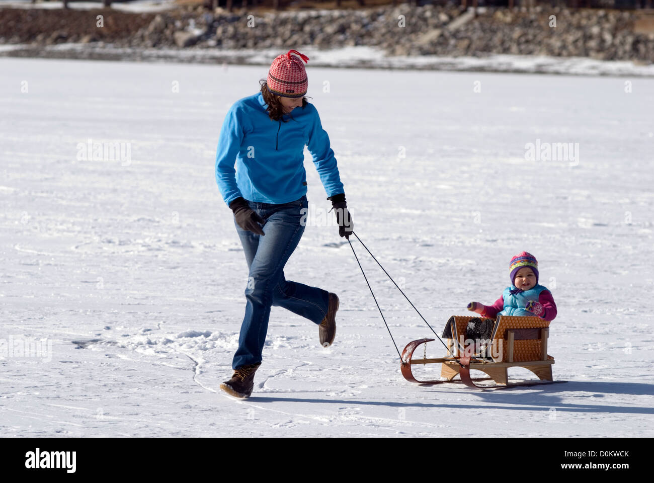 Pulling child in sled on Wallowa Lake, Oregon Stock Photo - Alamy