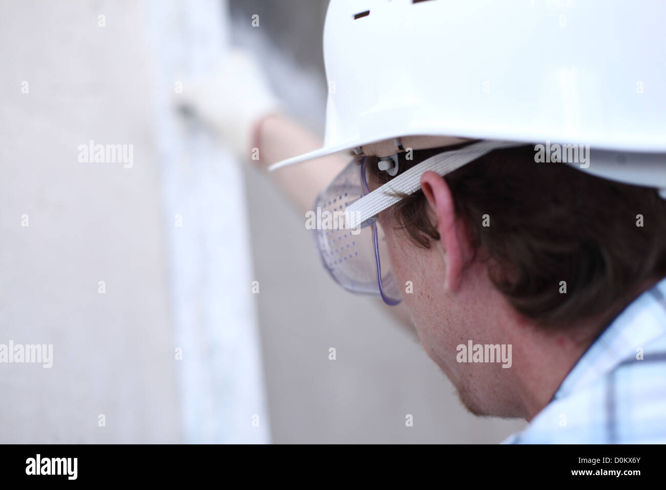 worker aligns wall for directing Stock Photo - Alamy