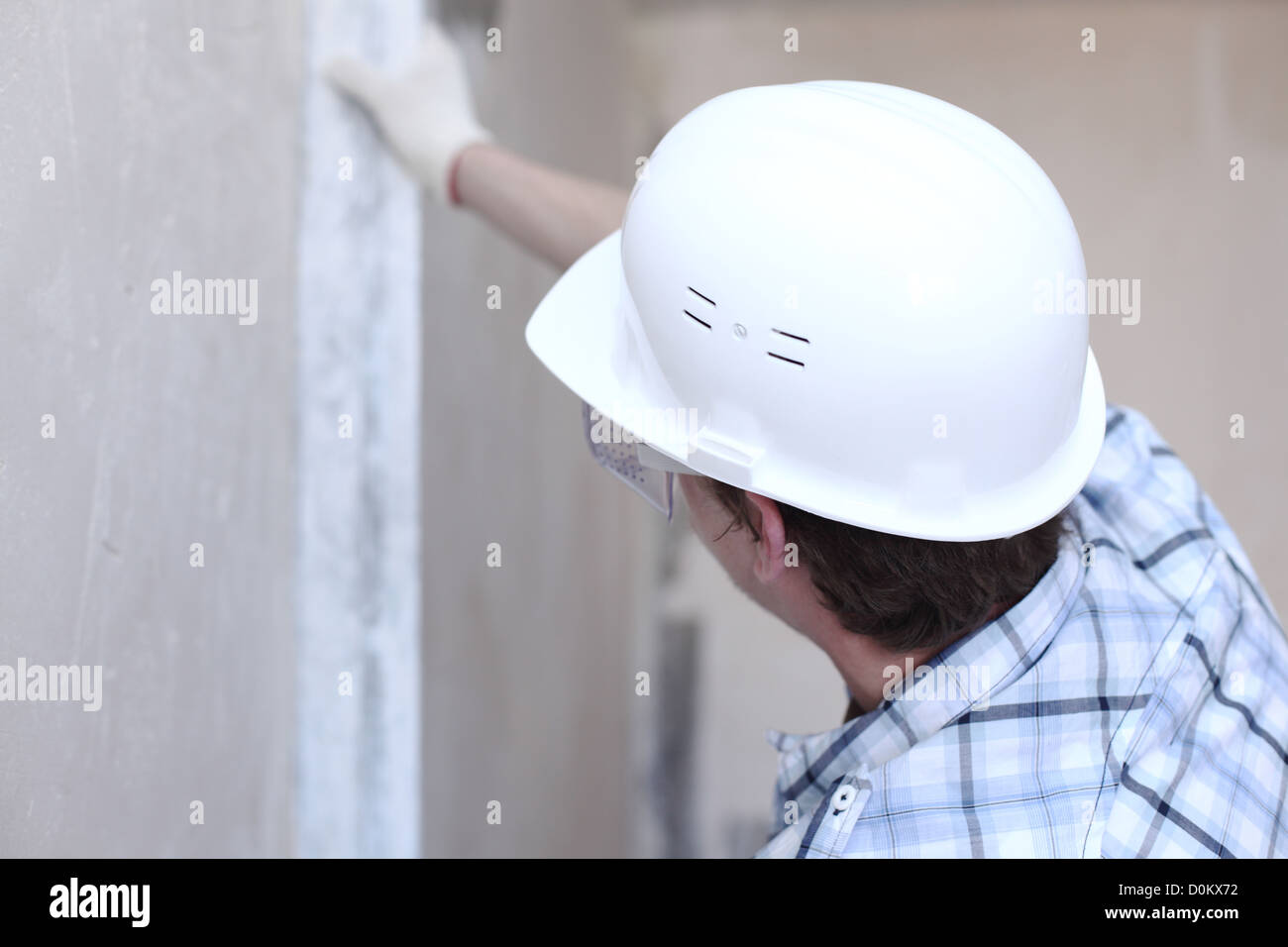 worker aligns wall for directing Stock Photo - Alamy