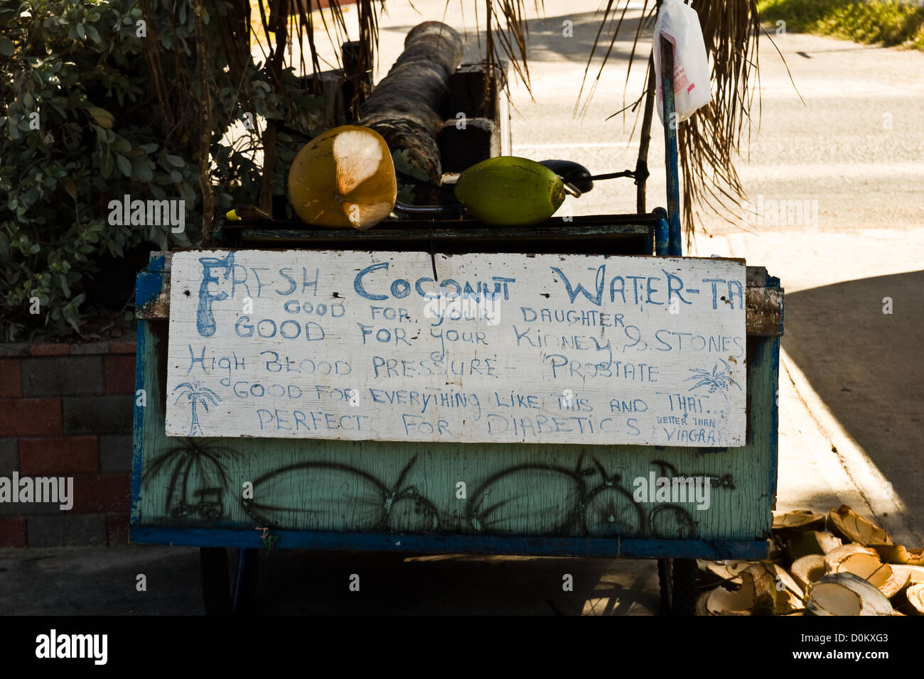 A vendor on the sidewalk selling fresh coconut water Stock Photo - Alamy