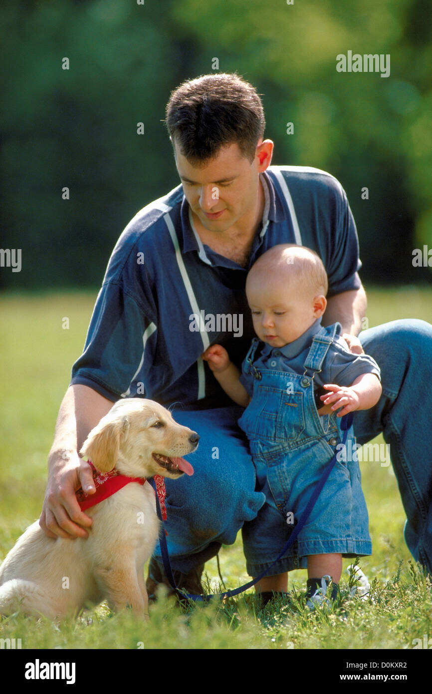 Father Introduces Son to New Puppy Stock Photo - Alamy