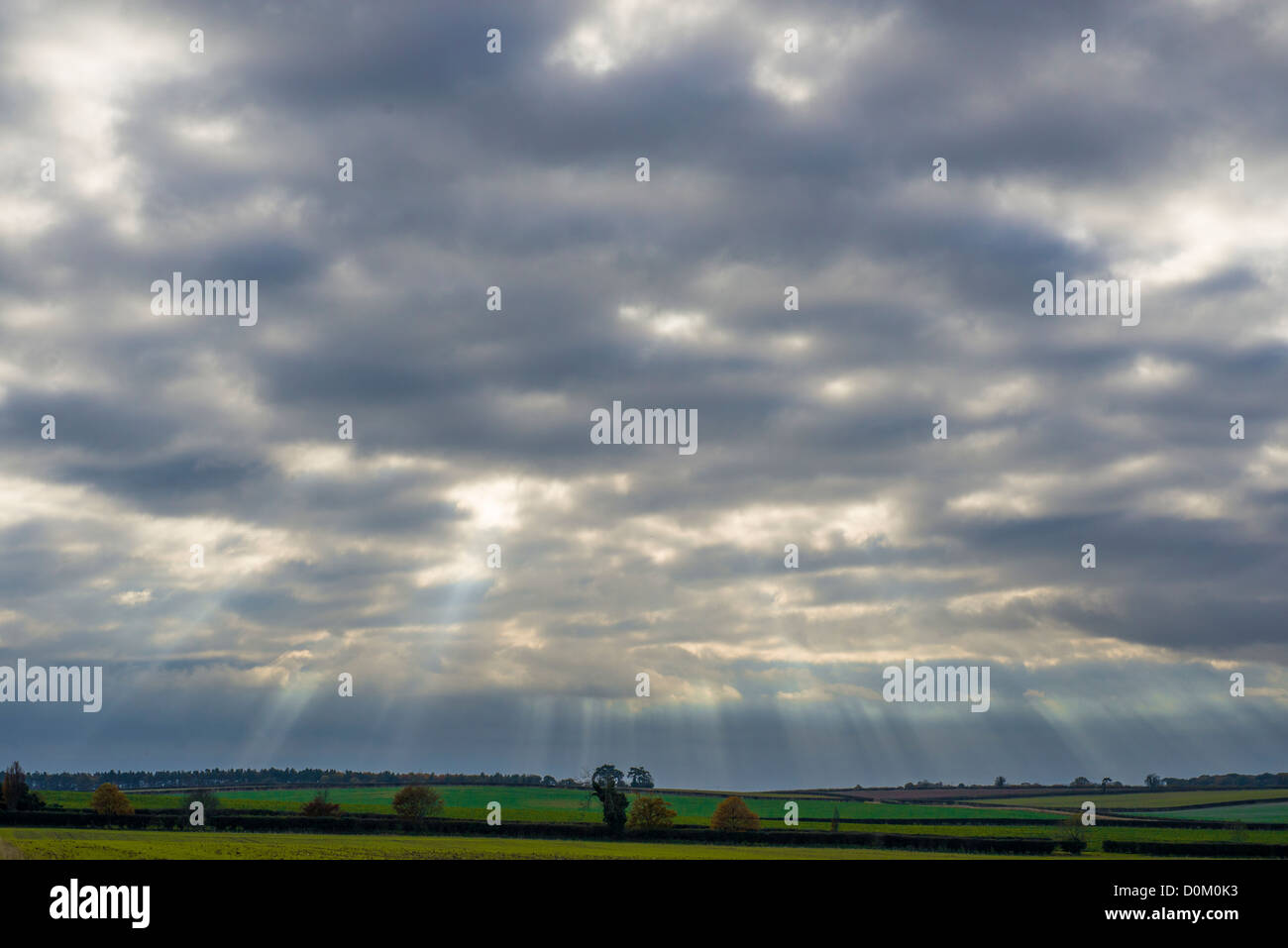 Evening sky over farmland with sun rays breaking through clouds Stock ...