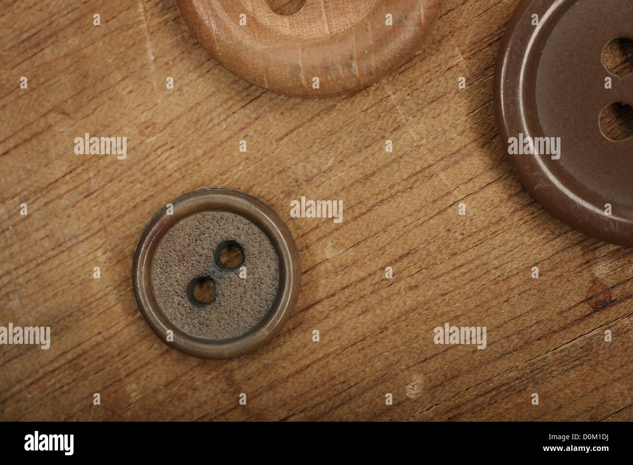 buttons on distressed wood Stock Photo - Alamy