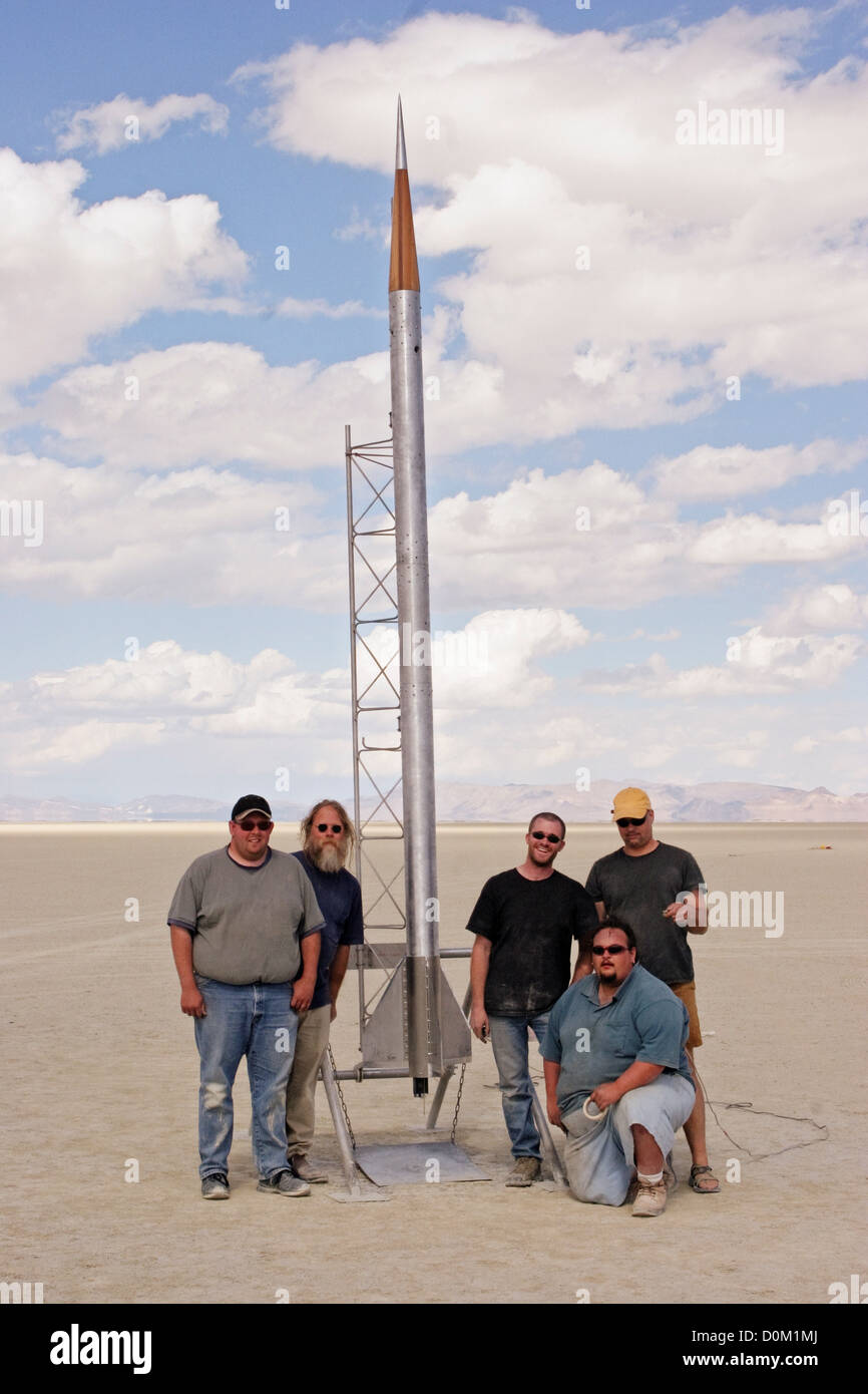 The crew Great Expectations pauses portrait around their rocket on its ...