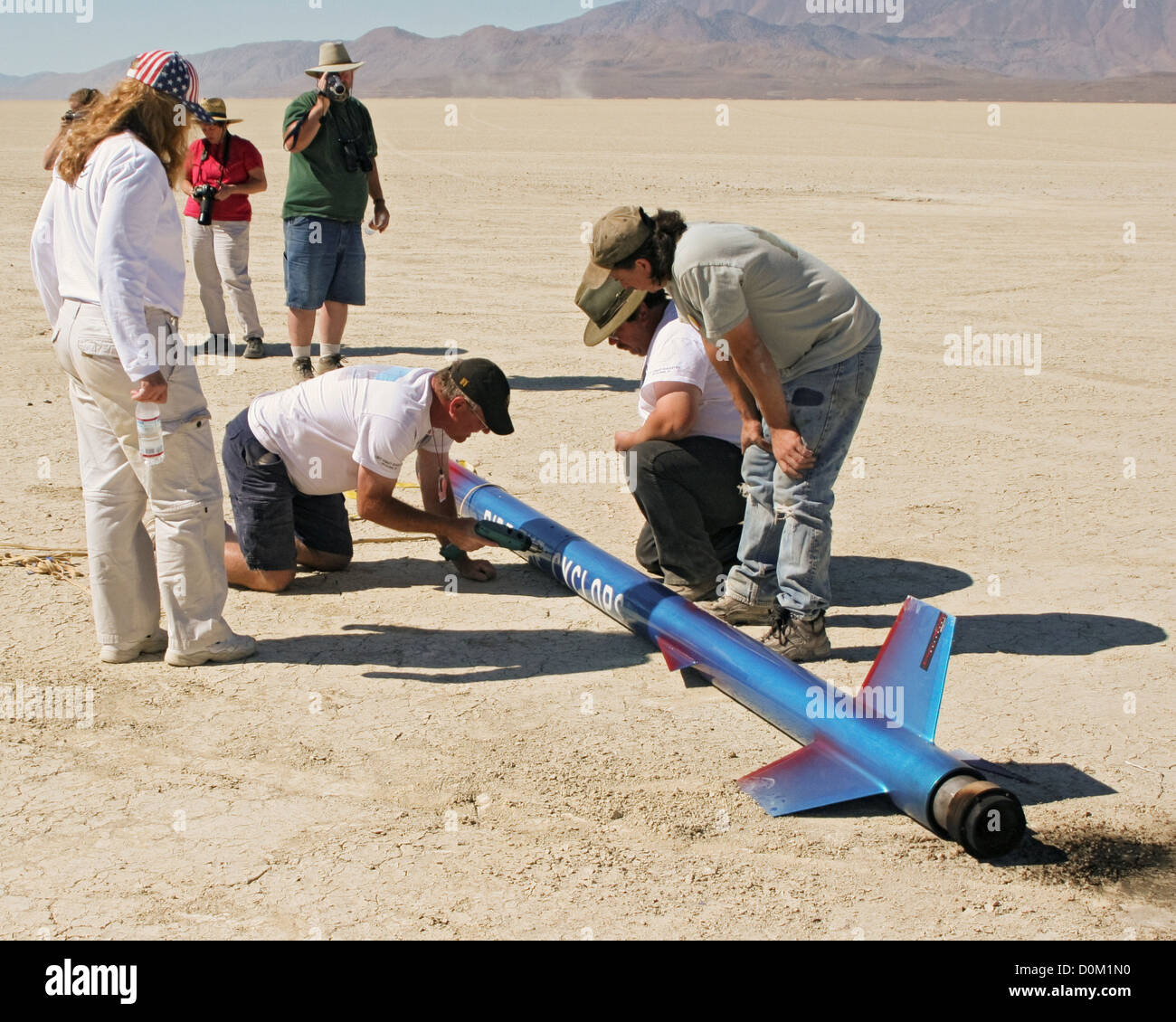 A team checks out a long blue rocket at BALLS, an experimental rocketry ...