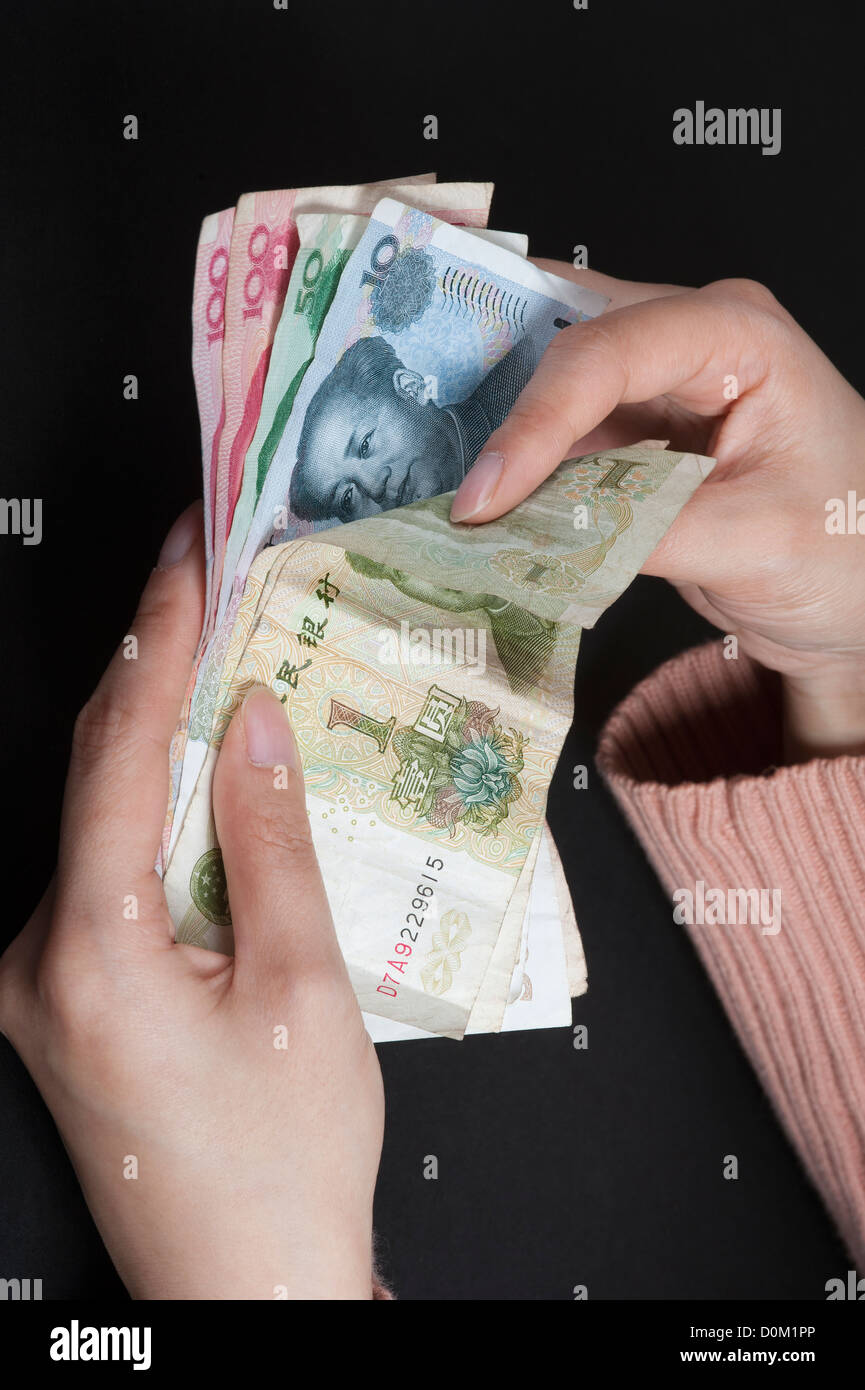 Female's hand holding Chinese Yuan banknotes Stock Photo - Alamy