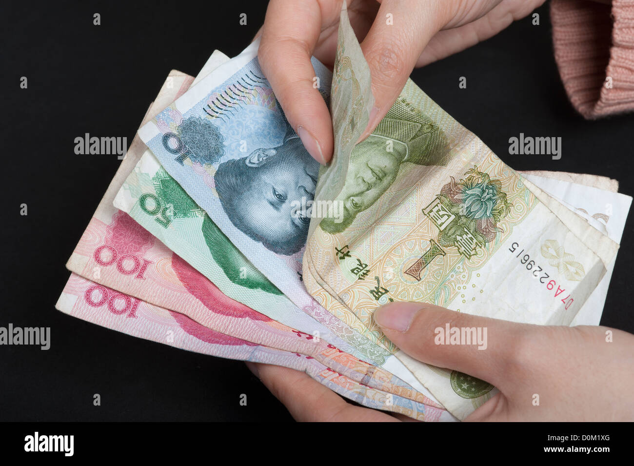 Female's hand holding Chinese Yuan banknotes Stock Photo - Alamy