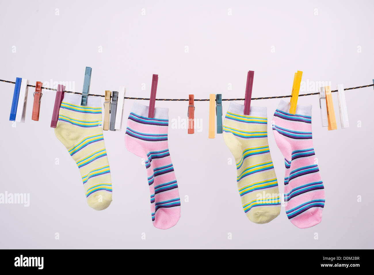 colorful socks hanging on the thread to dry Stock Photo - Alamy