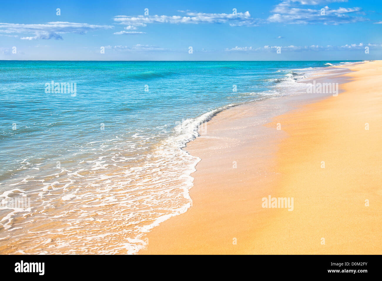 Sand beach with surf water background Stock Photo - Alamy