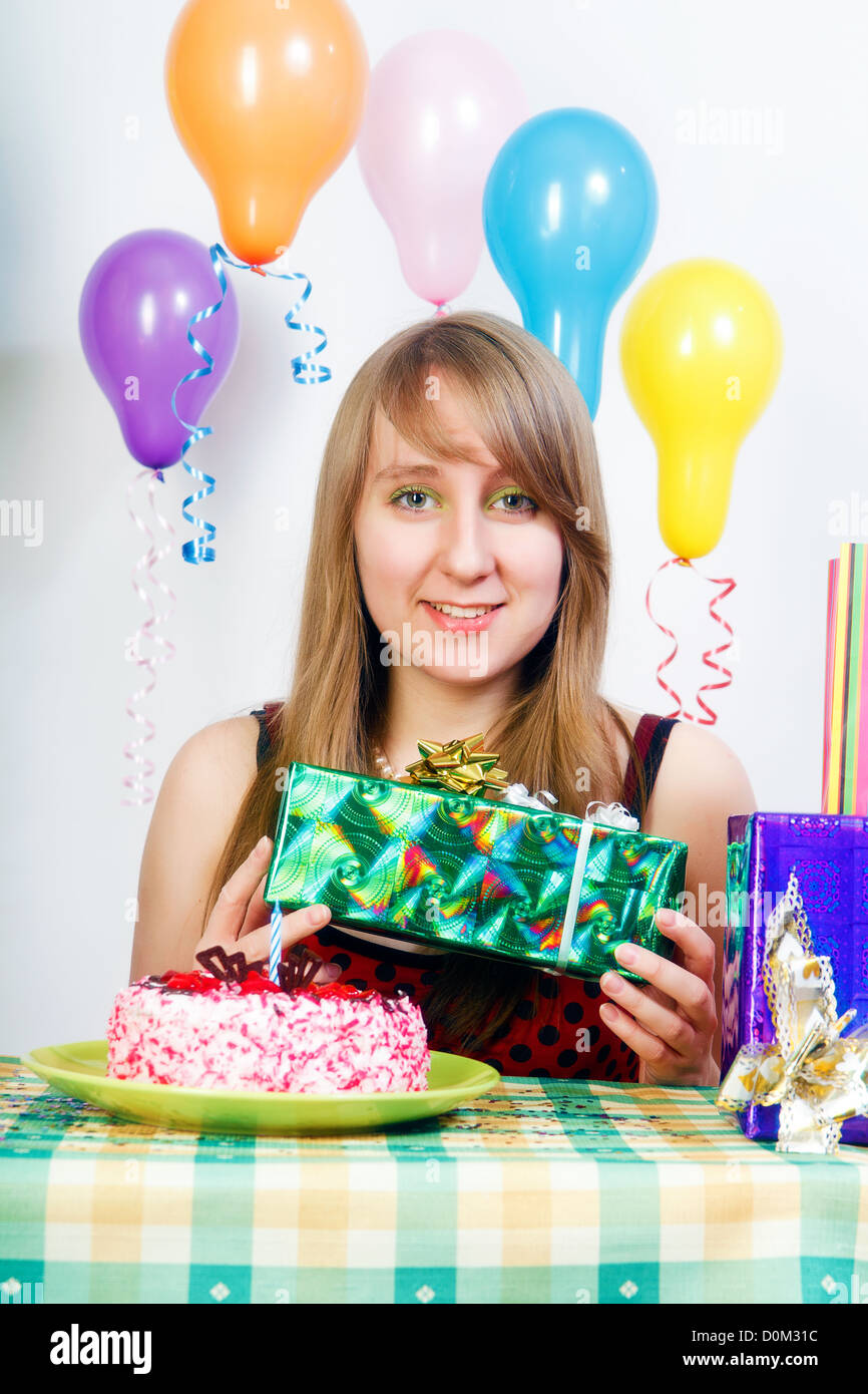 Birthday. Smiling girl with a gift in their hands Stock Photo - Alamy