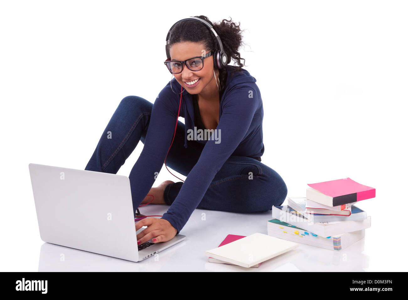 Young African student girl using a computer, isolated on white ...