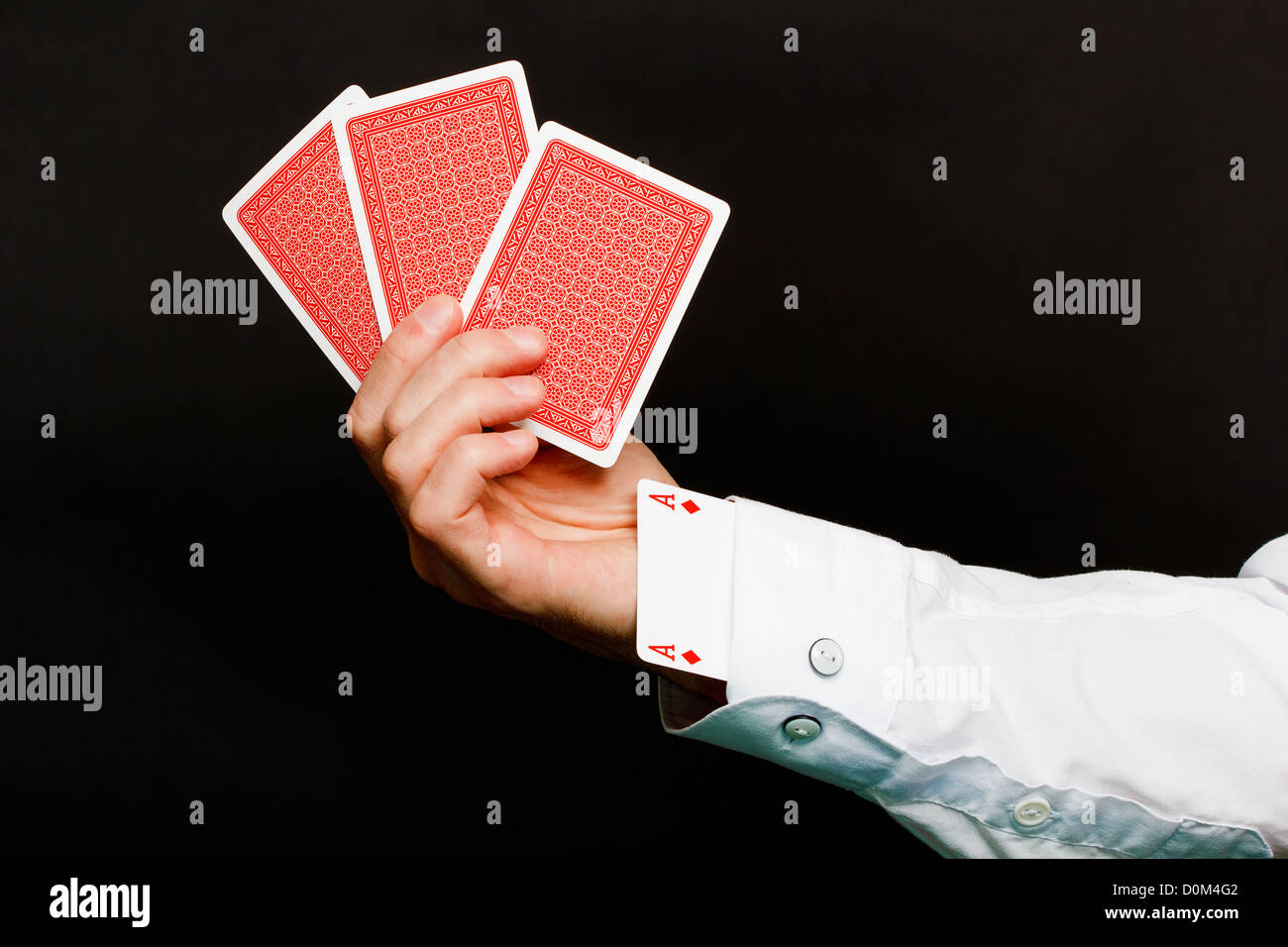 playing cards and an ace in the hole on a black background Stock Photo ...