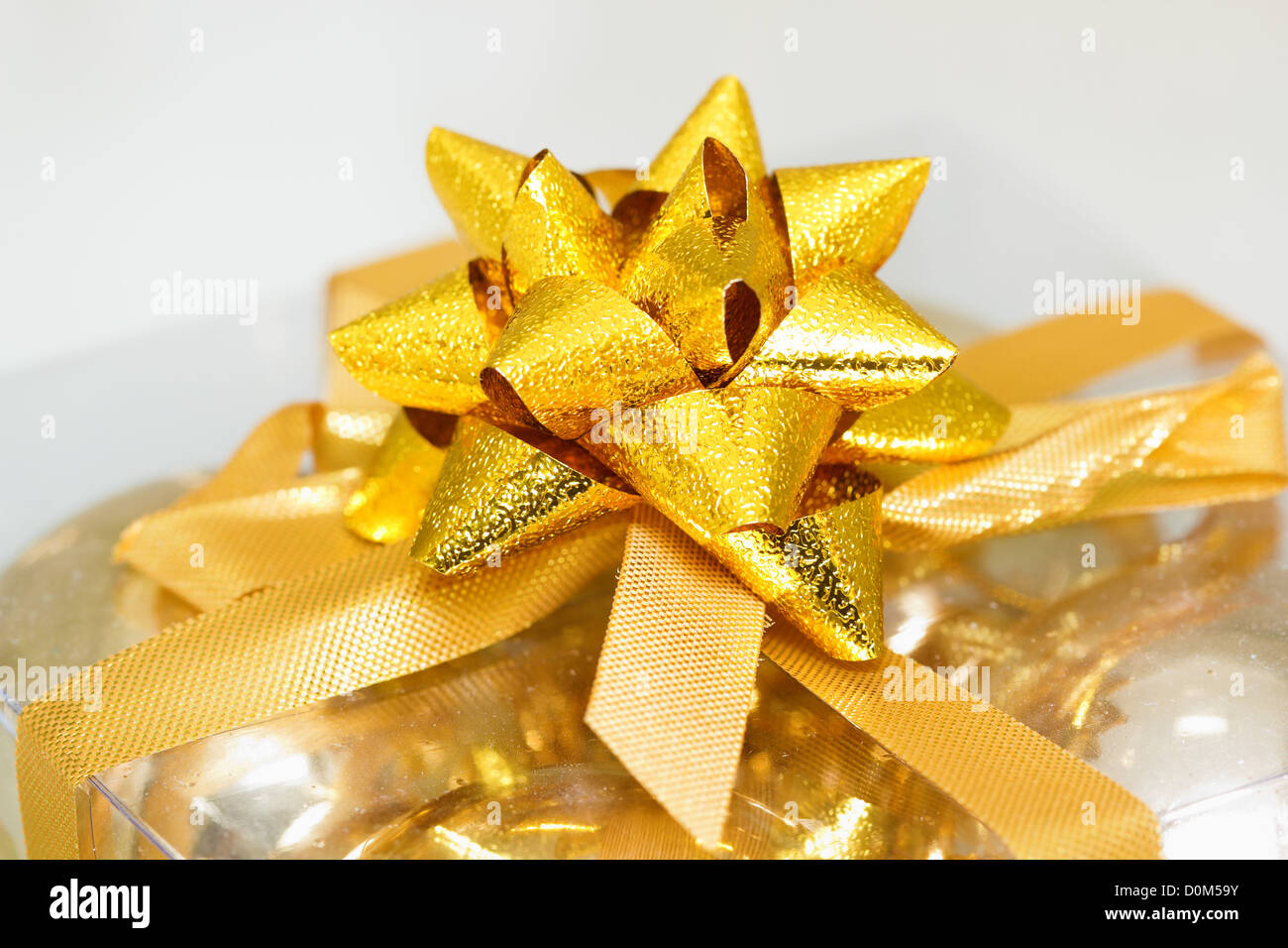golden bow on a gift box. Close-up Stock Photo - Alamy