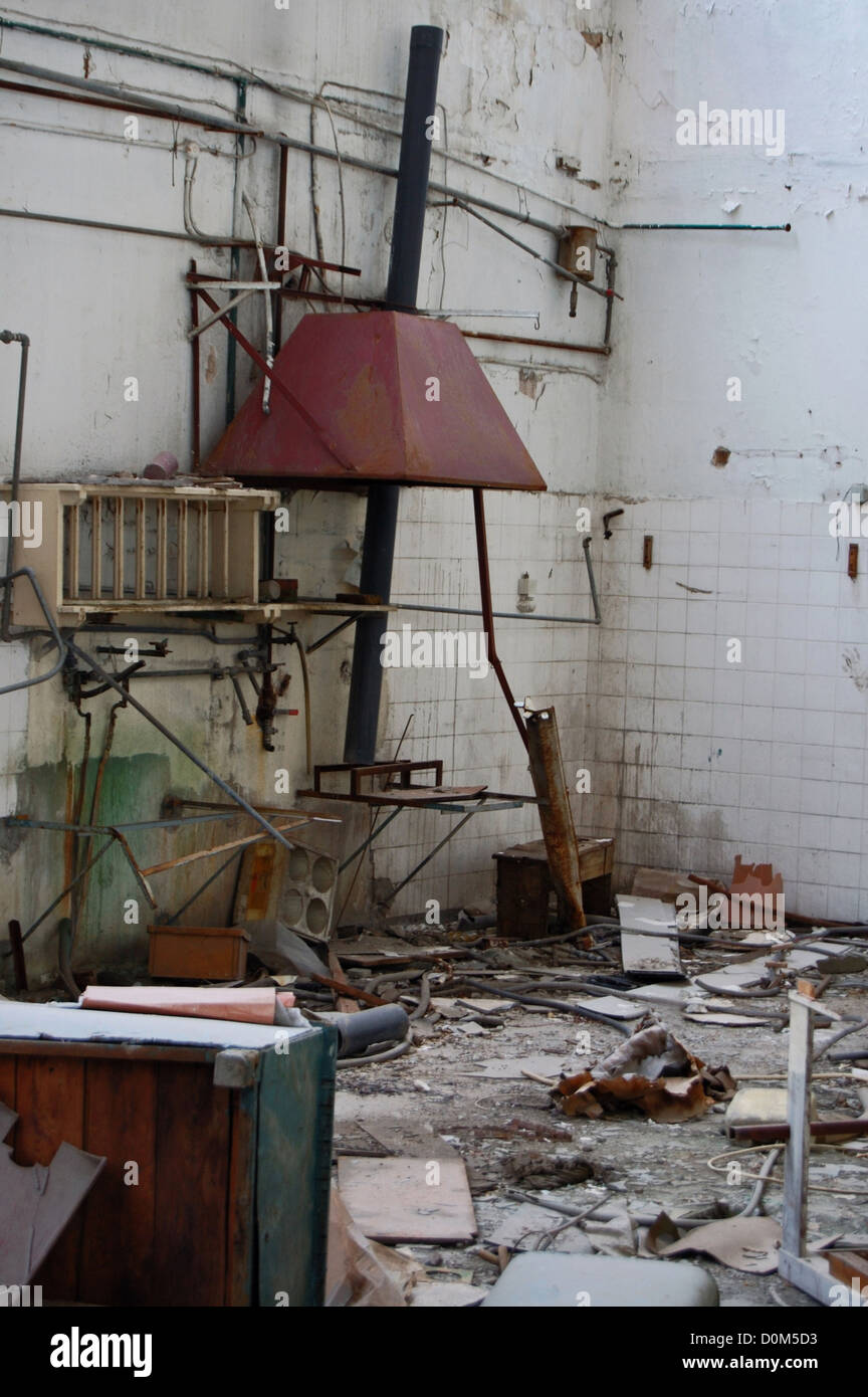 Discarded equipment and debris in abandoned factory decayed industrial ...