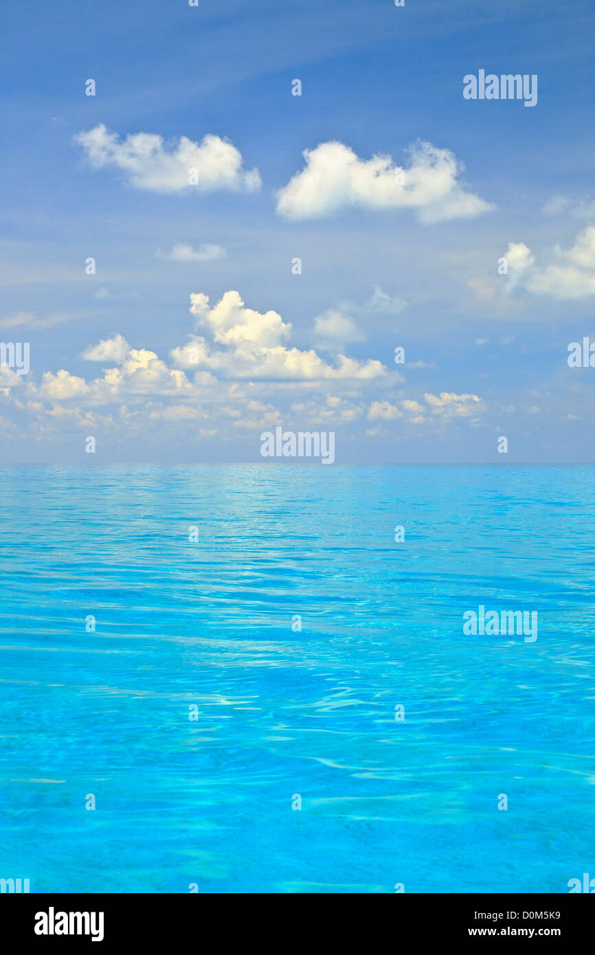 Calm flat ocean, White Puffy Clouds Stock Photo - Alamy