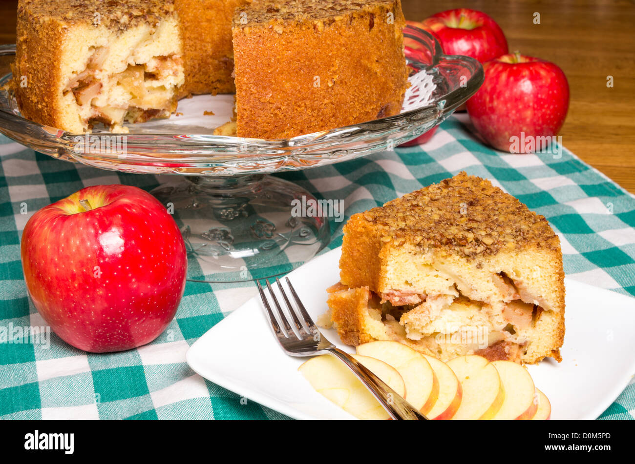 Apple cake with red apples and slice of cake with fork Stock Photo - Alamy
