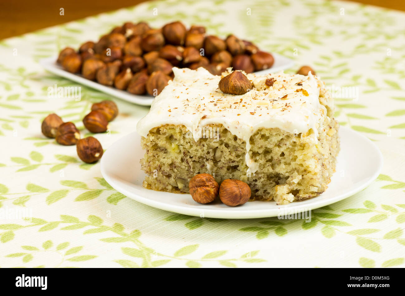 A slice of apple hazelnut cake on white plate Stock Photo - Alamy