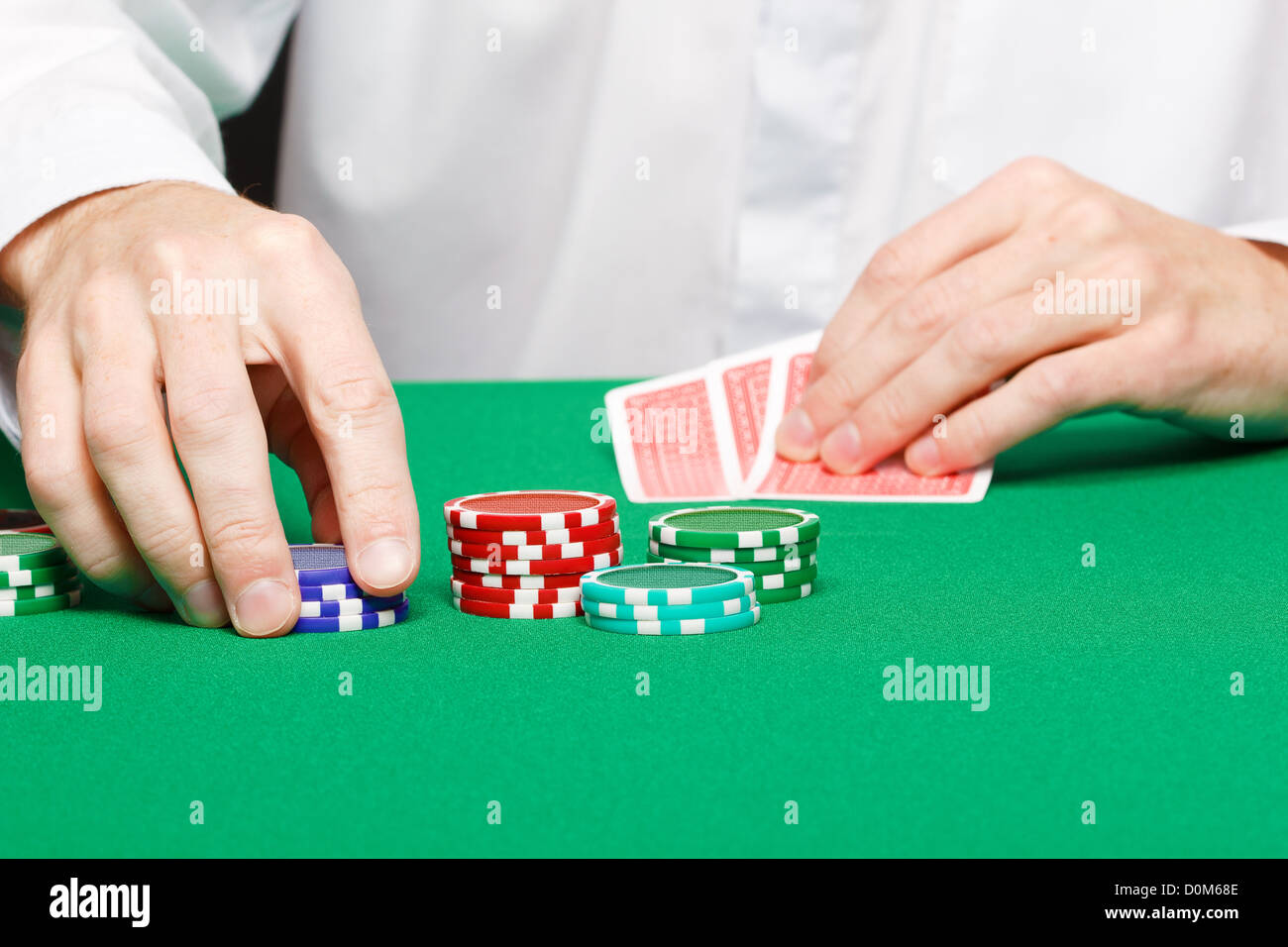 Man with cards on a gambling table Stock Photo - Alamy