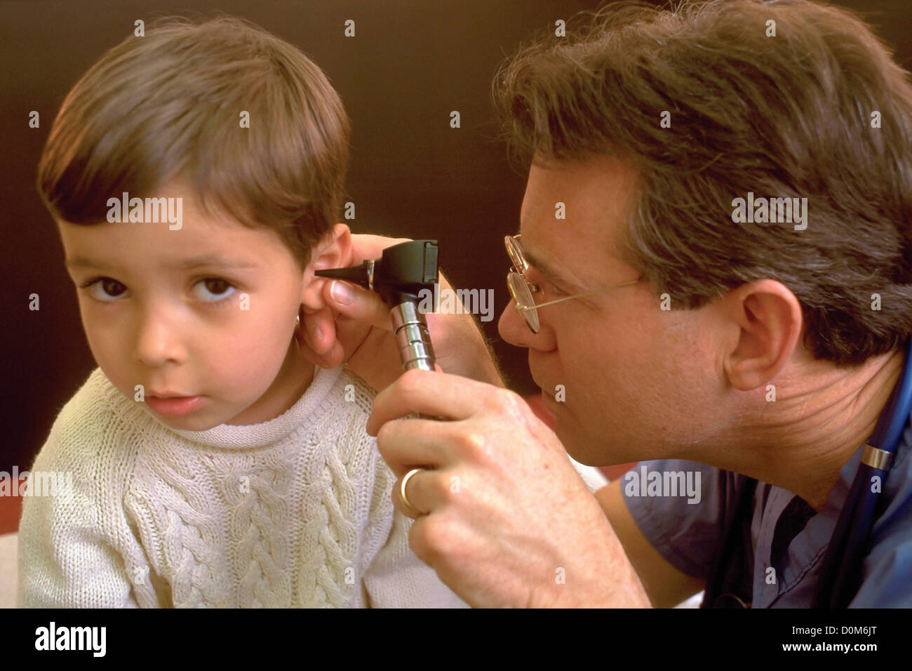 Pediatrician Examines Patient's Ear Stock Photo - Alamy