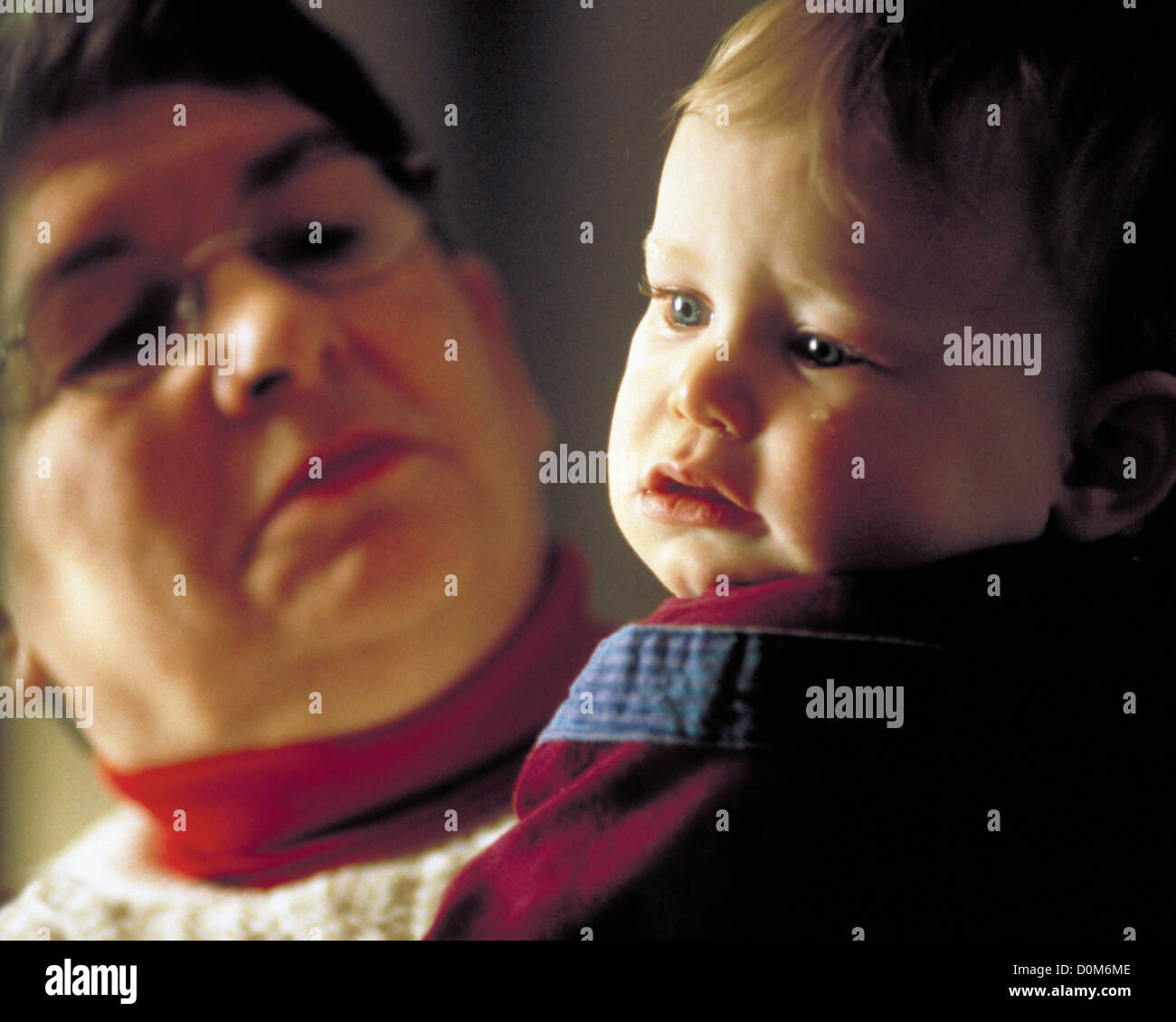 Daycare Worker Holds Crying Baby Stock Photo - Alamy