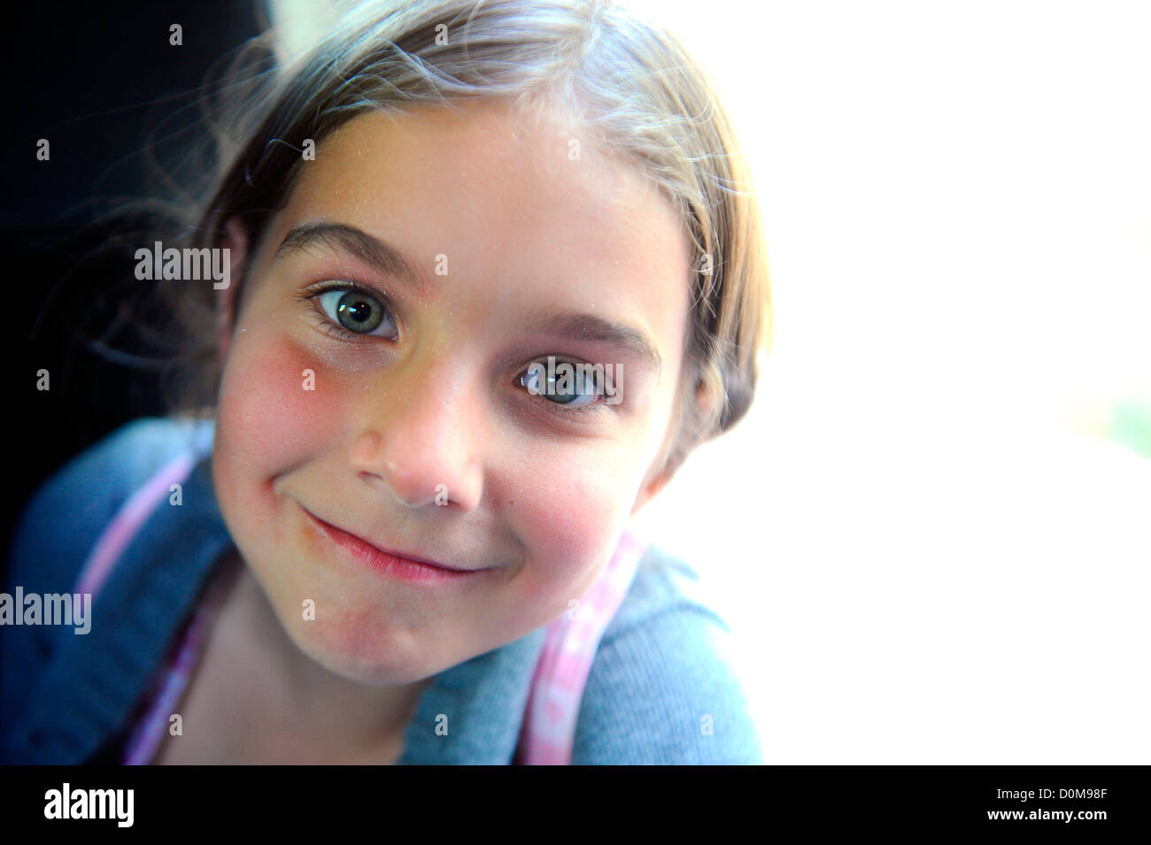 Girl looking up and grinning Stock Photo - Alamy