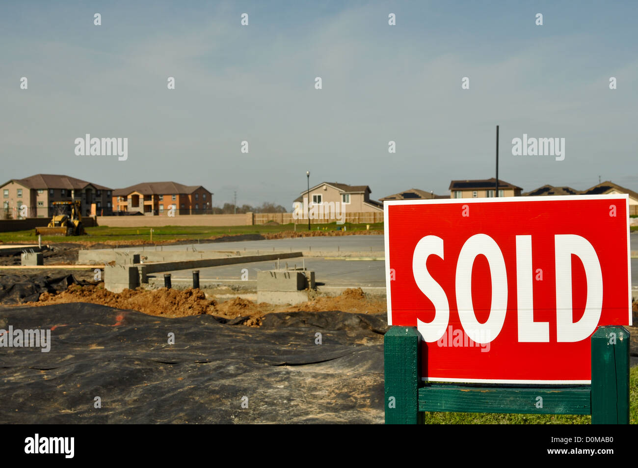 Red and white Sold Sign with new homes in the background Stock Photo ...