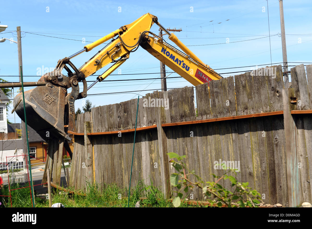 Fence being demolished by an excavator Stock Photo - Alamy