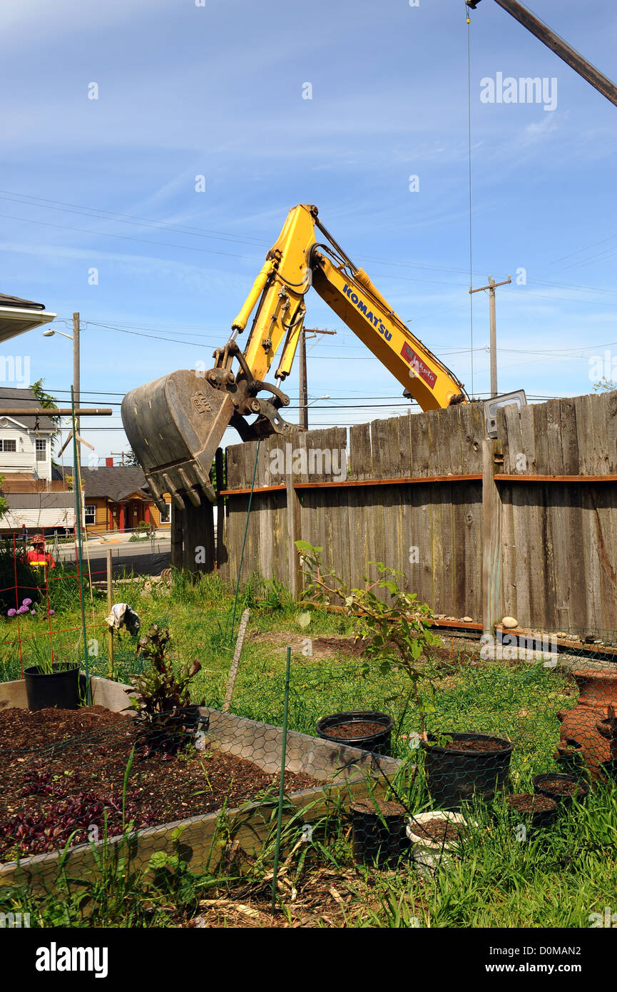 Fence being demolished by an excavator Stock Photo - Alamy