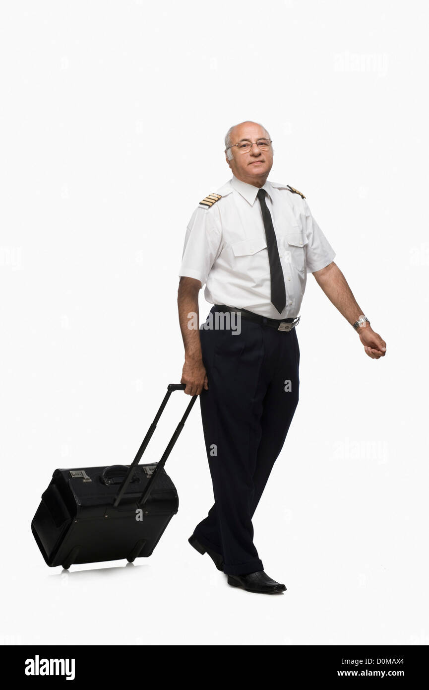 Portrait of a pilot carrying a luggage Stock Photo - Alamy