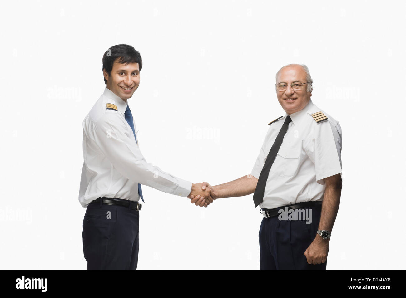 Two pilots shaking hands and smiling Stock Photo - Alamy