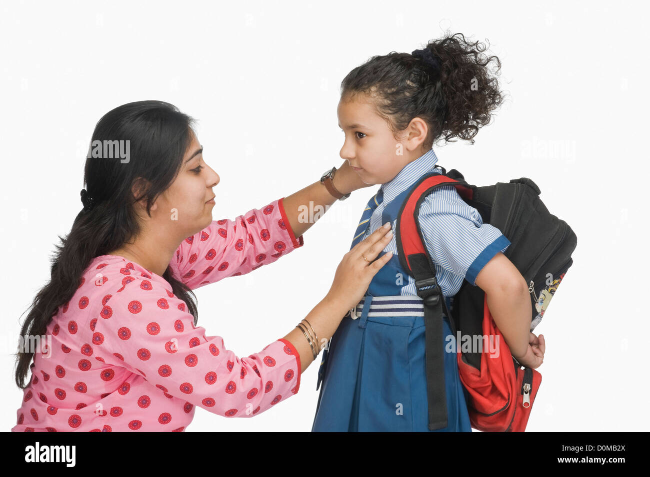 Woman preparing her daughter for school Stock Photo - Alamy