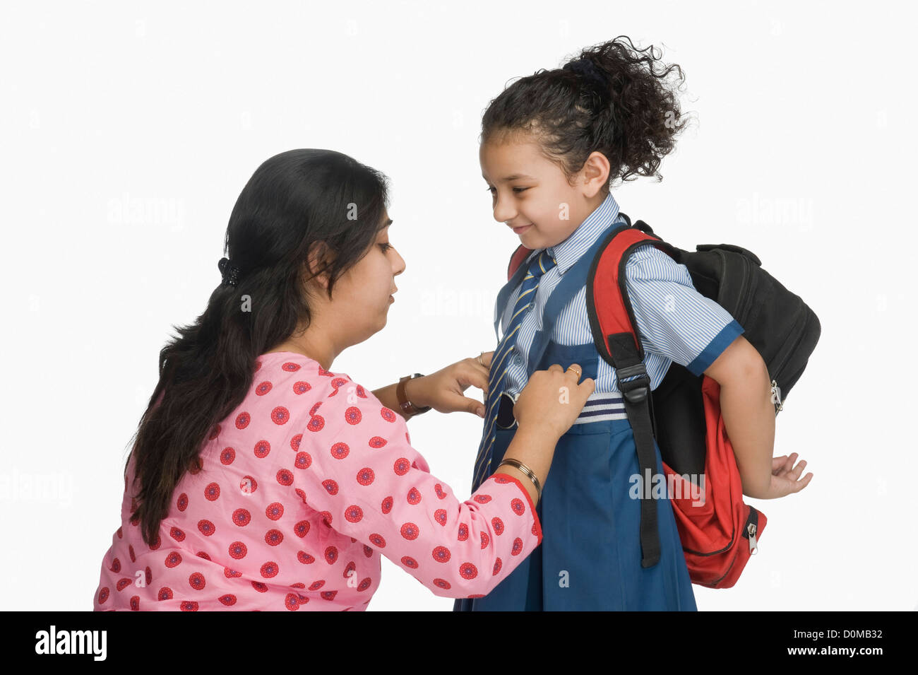 Woman preparing her daughter for school Stock Photo - Alamy