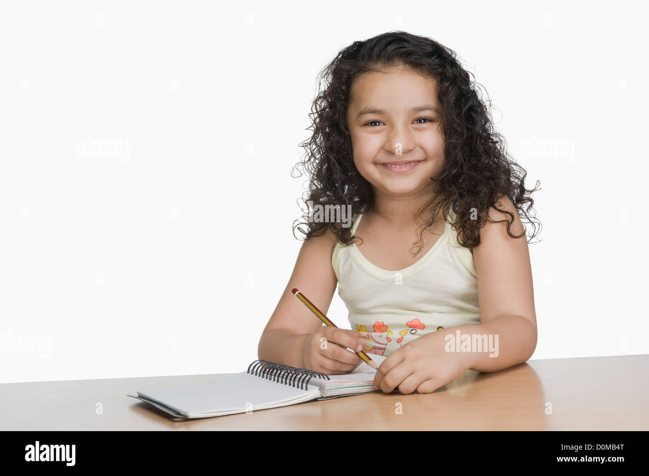 Portrait of a girl writing and smiling Stock Photo - Alamy