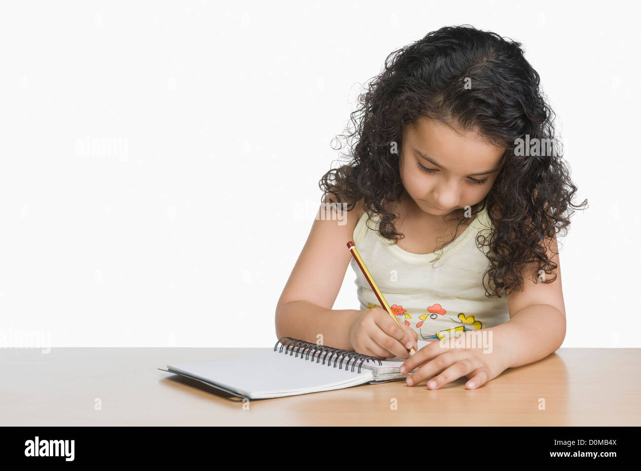 Indian girl writing in notebook hi-res stock photography and images - Alamy