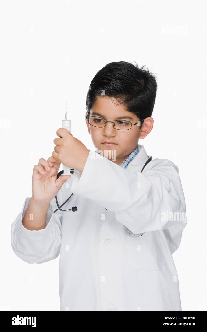 Boy imitating a doctor and holding a medical injection Stock Photo - Alamy