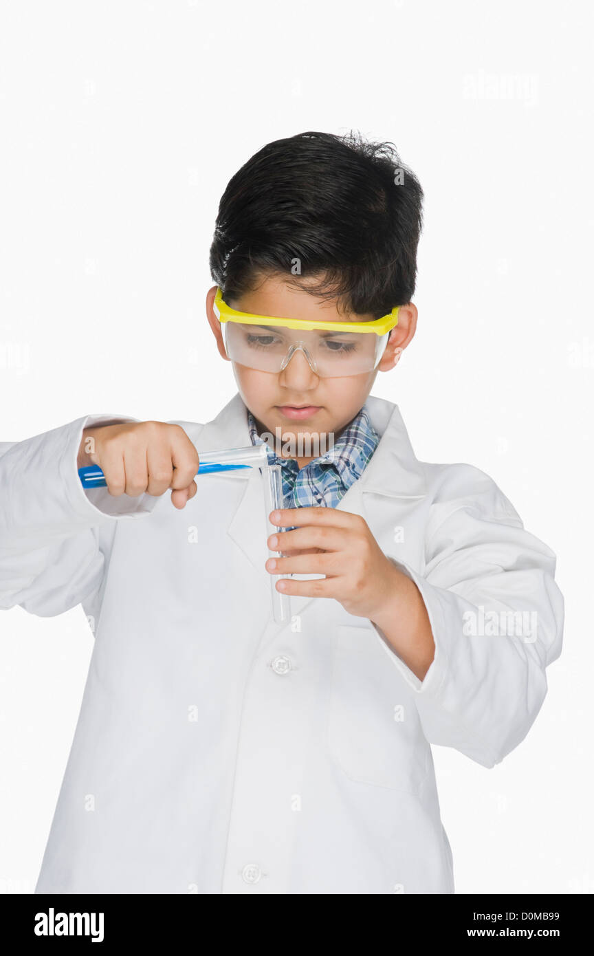 Boy in a lab coat experimenting with test tubes Stock Photo - Alamy